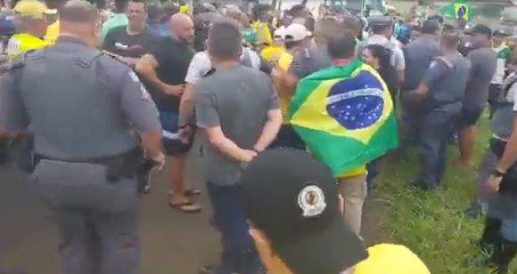 Driver decides to run over rioters.
